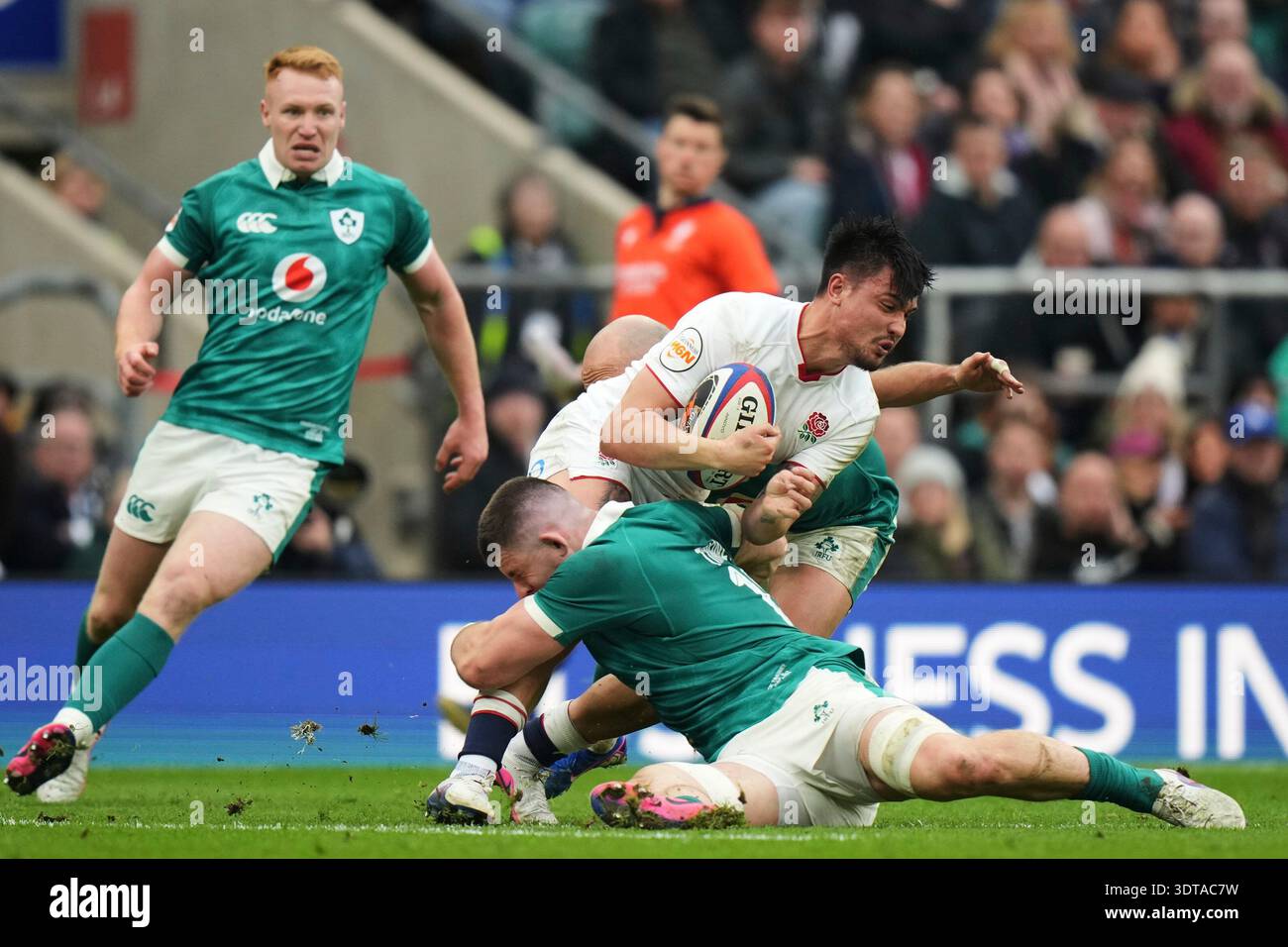 England's Marcus Smith, right, is tackled by Ireland's Nick Timoney ...