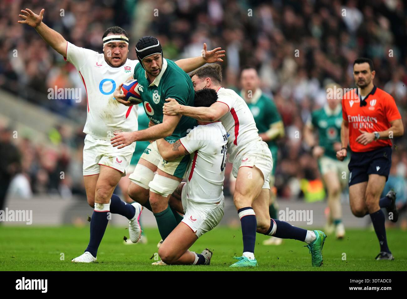 Ireland's captain Caelan Doris, center, is tackled by England's Marcus ...