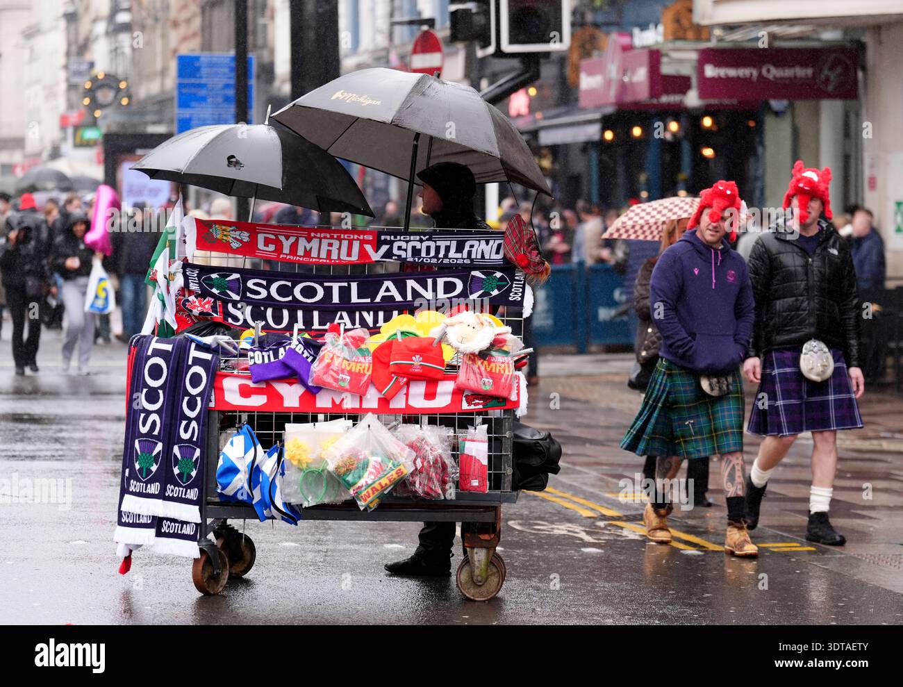 Scotland fans walk past a stand selling Wales and Scotland merchandise ...