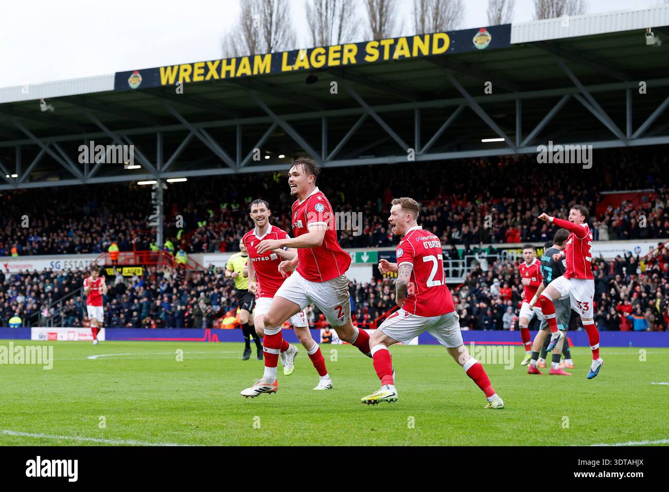 Wrexham's Callum Doyle (centre) celebrates scoring their side's fourth ...