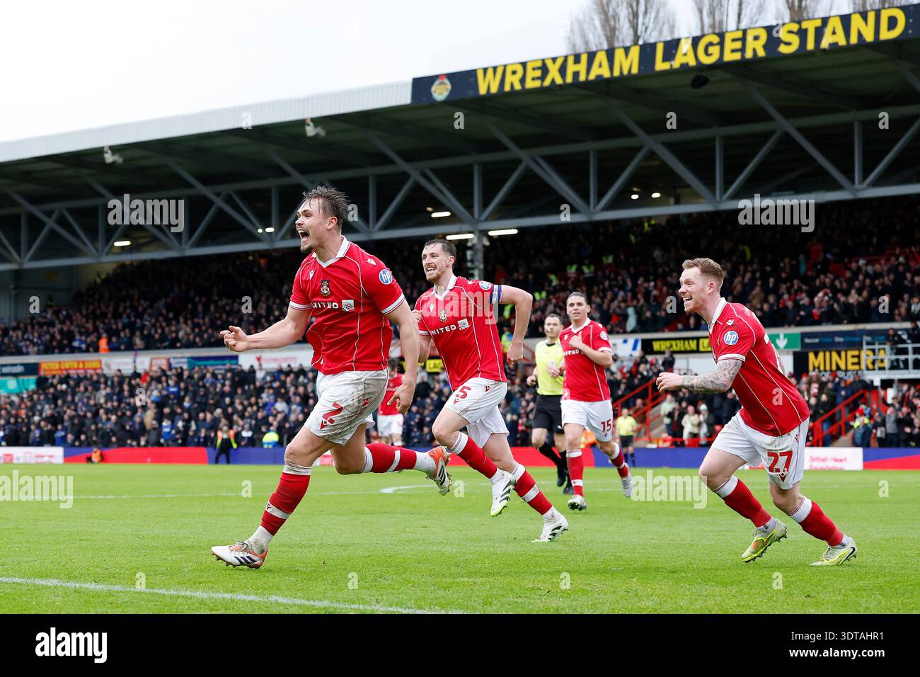 Wrexham's Callum Doyle (left) celebrates scoring their side's fourth ...