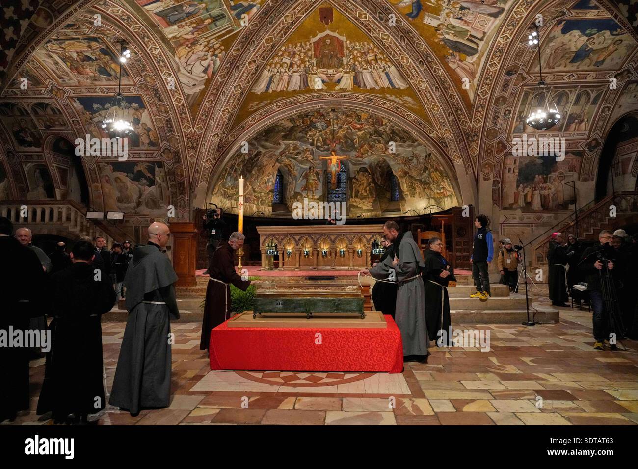 Friars pray before the remains of Francis of Assisi inside the Basilica ...