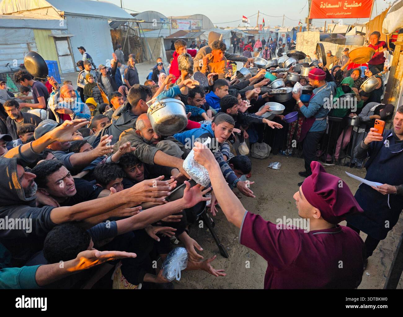 Displaced Palestinian struggle to receive donated food for iftar, the ...
