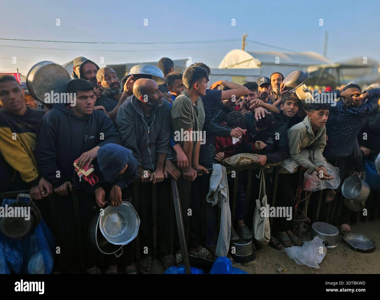 Displaced Palestinian struggle to receive donated food for iftar, the ...