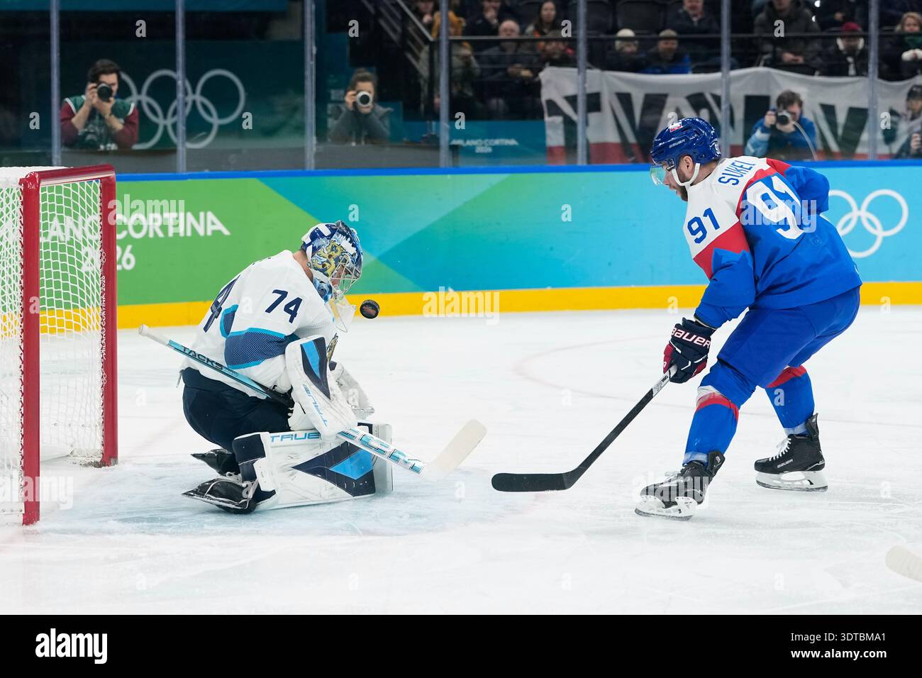 Finland's goalkeeper Juuse Saros (74) blocks a shot from Slovakia's ...