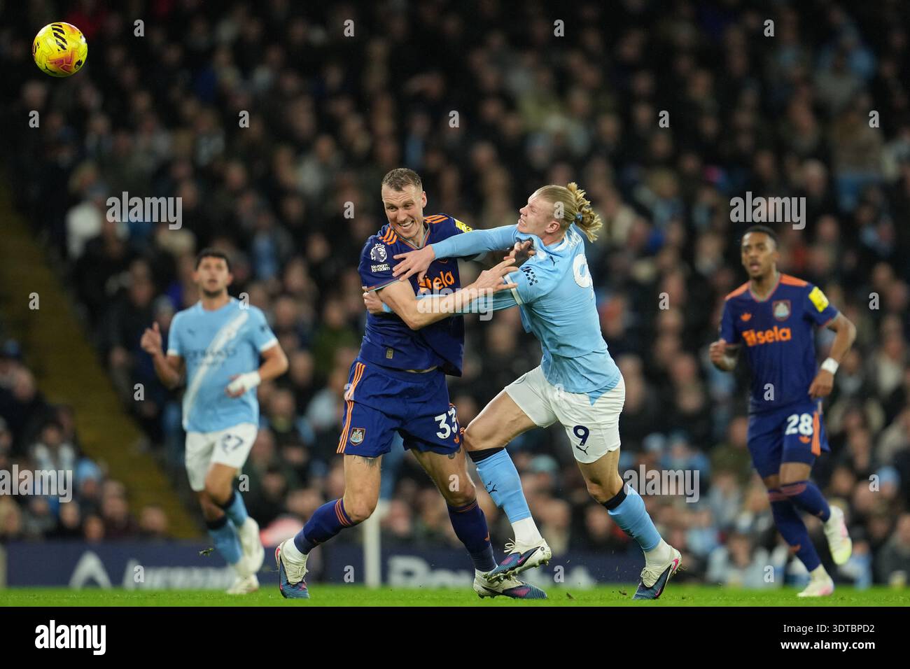 Newcastle's Dan Burn, left, and Manchester City's Erling Haaland fight ...