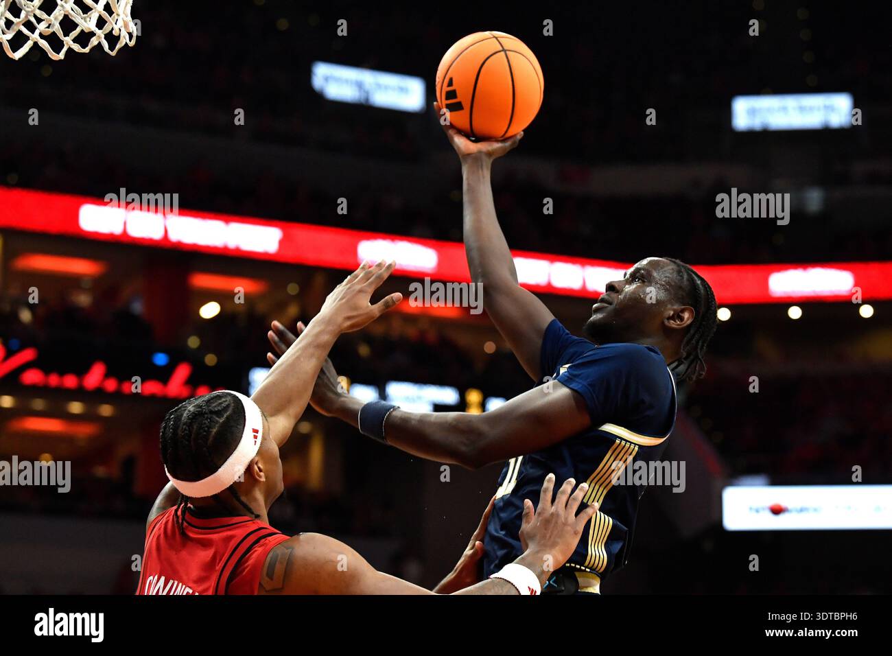 Georgia Tech forward Baye Ndongo (11) attempts a layup over Louisville ...