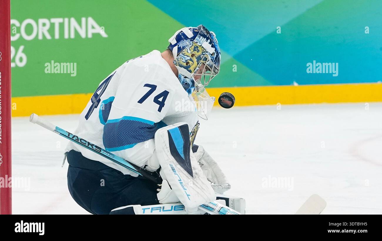 Finland's goalkeeper Juuse Saros (74) blocks a shot from Slovakia's ...