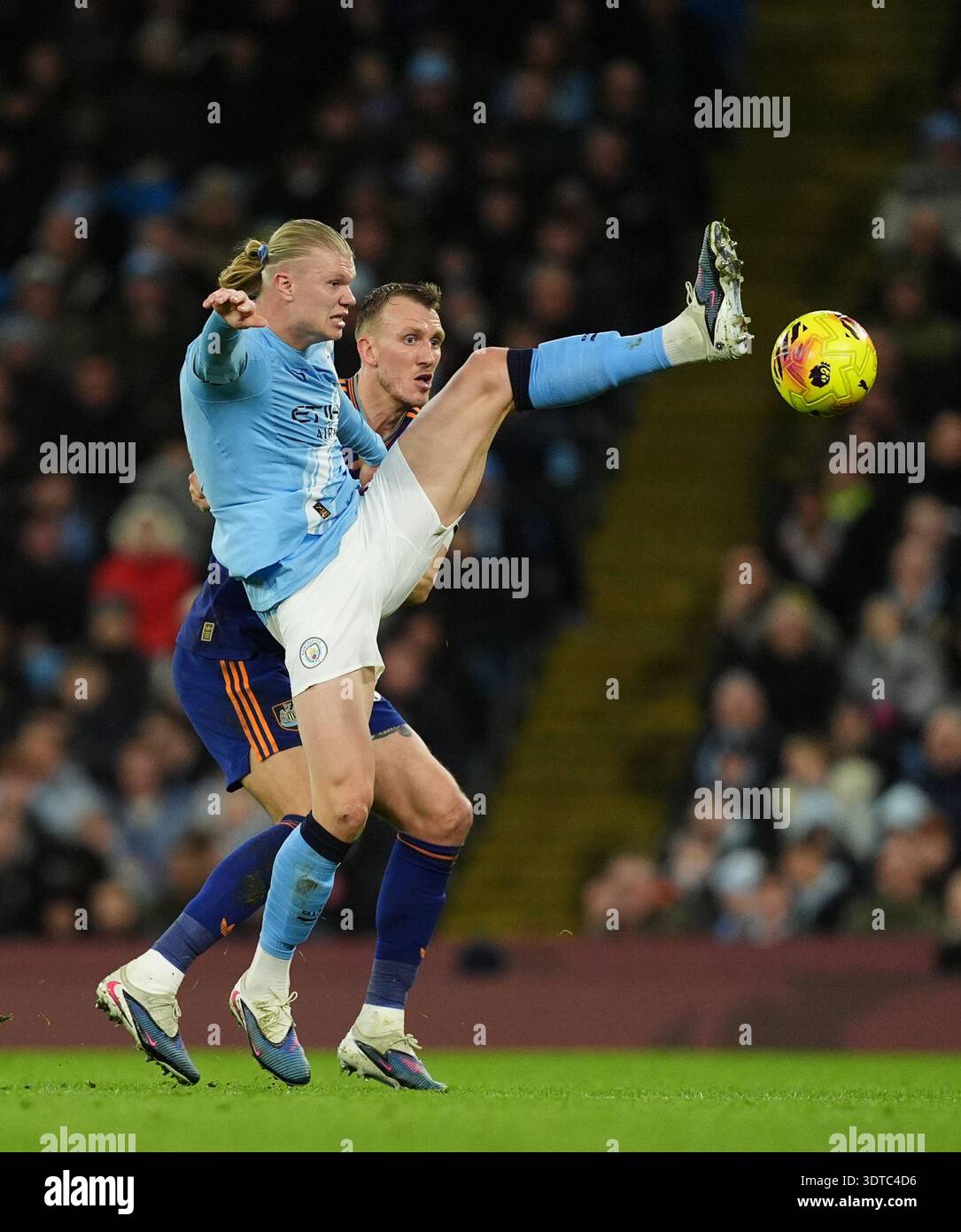 Newcastle United's Dan Burn and Manchester City's Erling Haaland battle ...