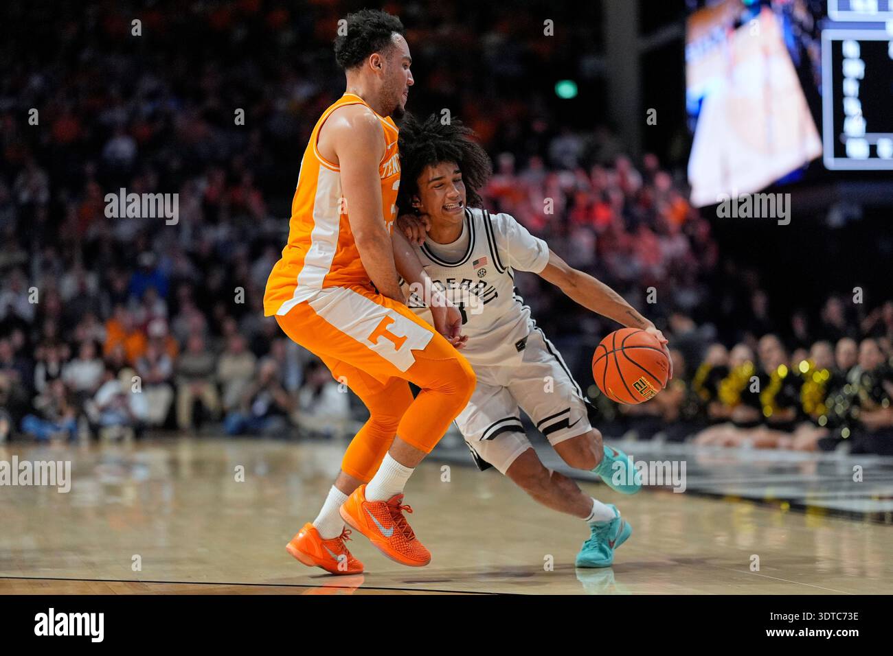 Vanderbilt guard Tyler Tanner, right, dribbles the ball past Tennessee ...