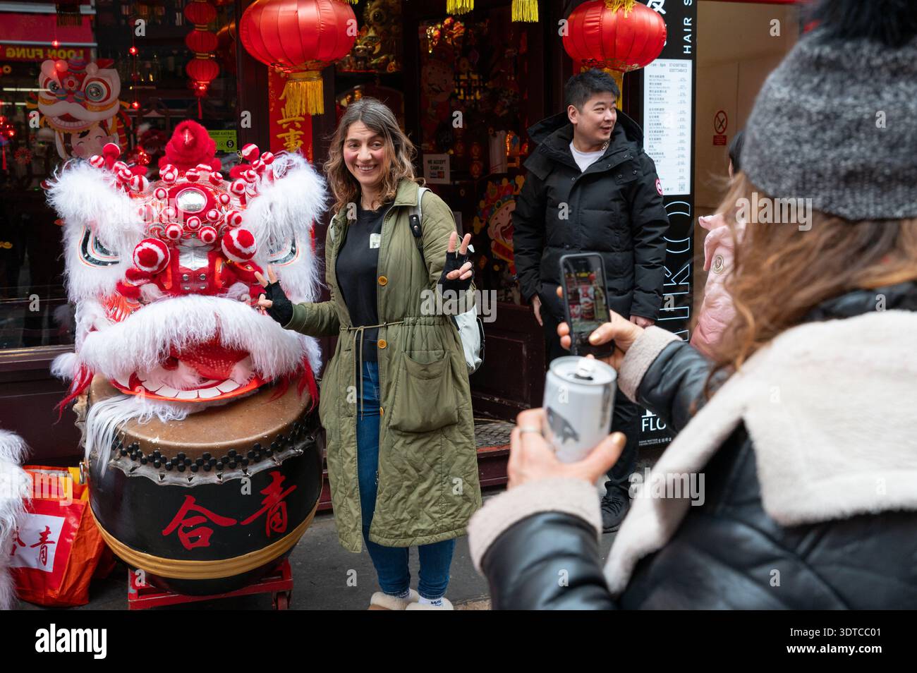 Tourists taking photos with the Lion mask. Performers in traditional ...