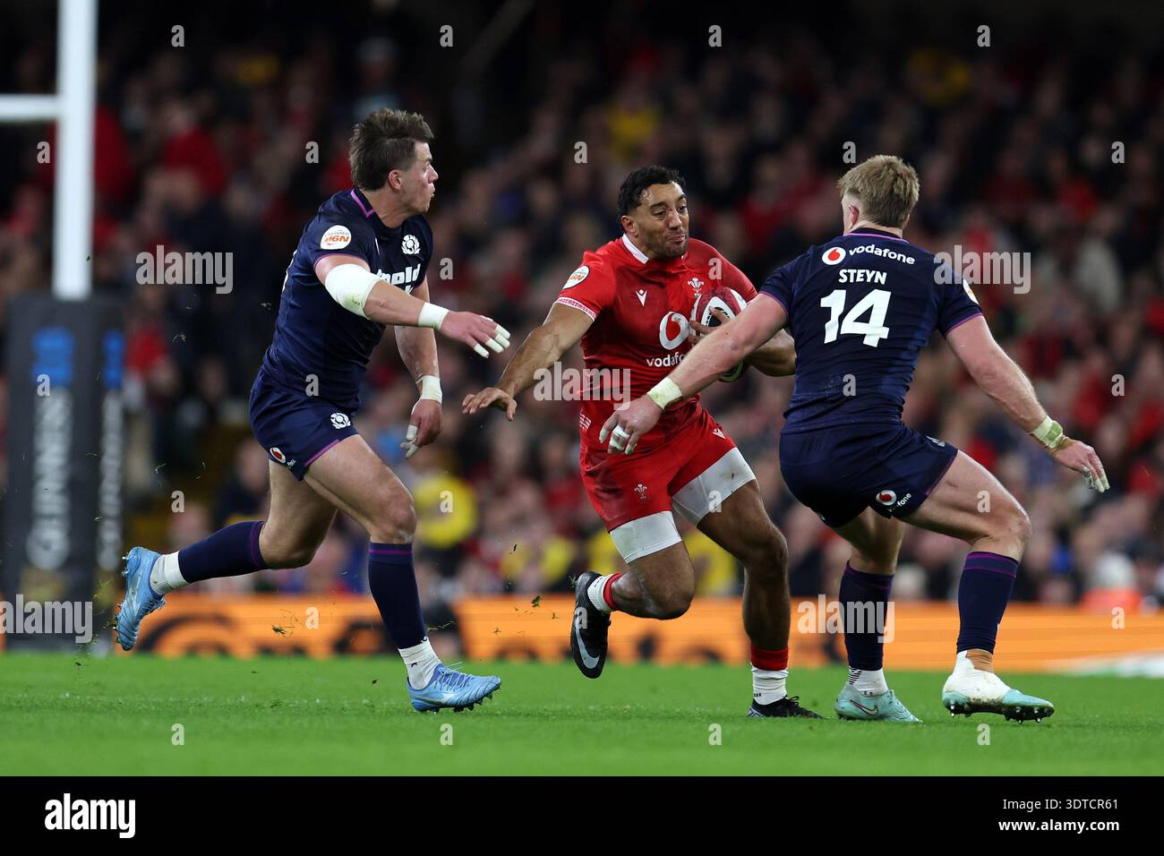 Gabriel Hamer-Webb of Wales (c) tries to go past Huw Jones (l) & Kyle ...