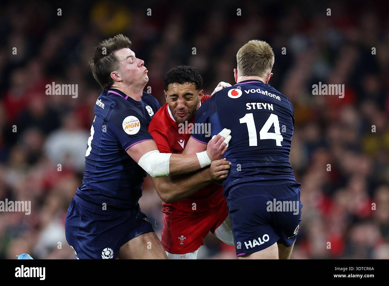 Gabriel Hamer-Webb of Wales is stopped by Huw Jones (l) & Kyle Steyn of ...