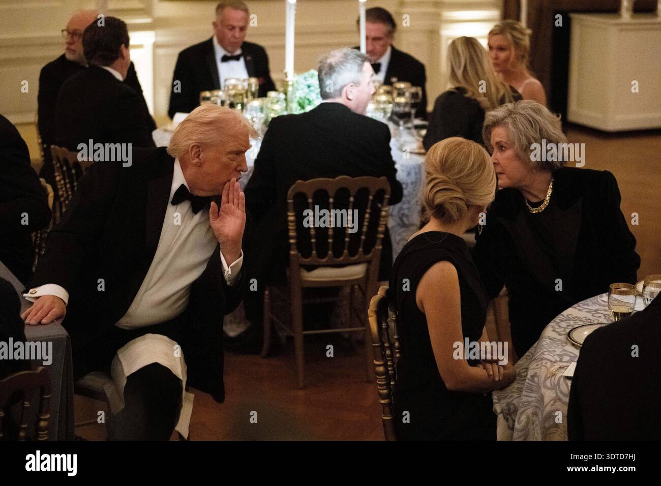 President Donald Trump speaks to White House Chief of Staff Susie Wiles ...
