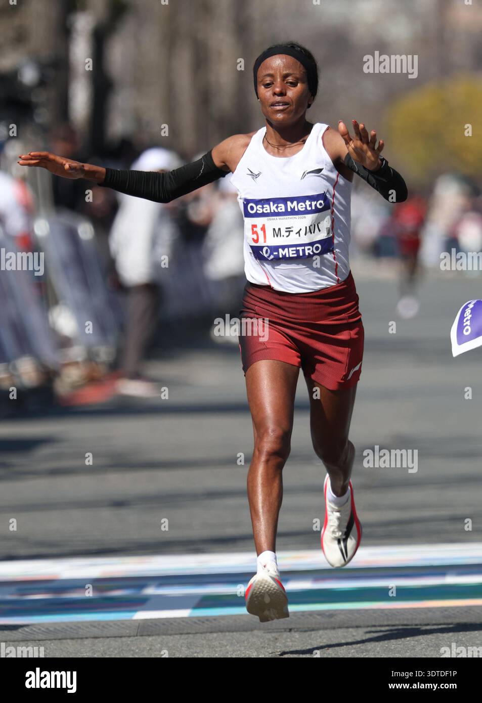 Mare Dibaba Hurrsa crosses the finish line as the first runner during ...