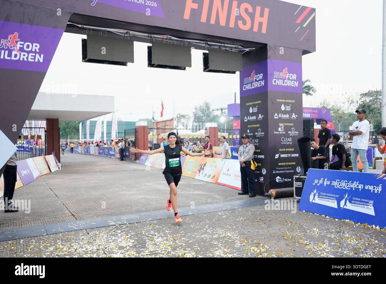 A competitor crosses the finish line in the Yoma Yangon International ...