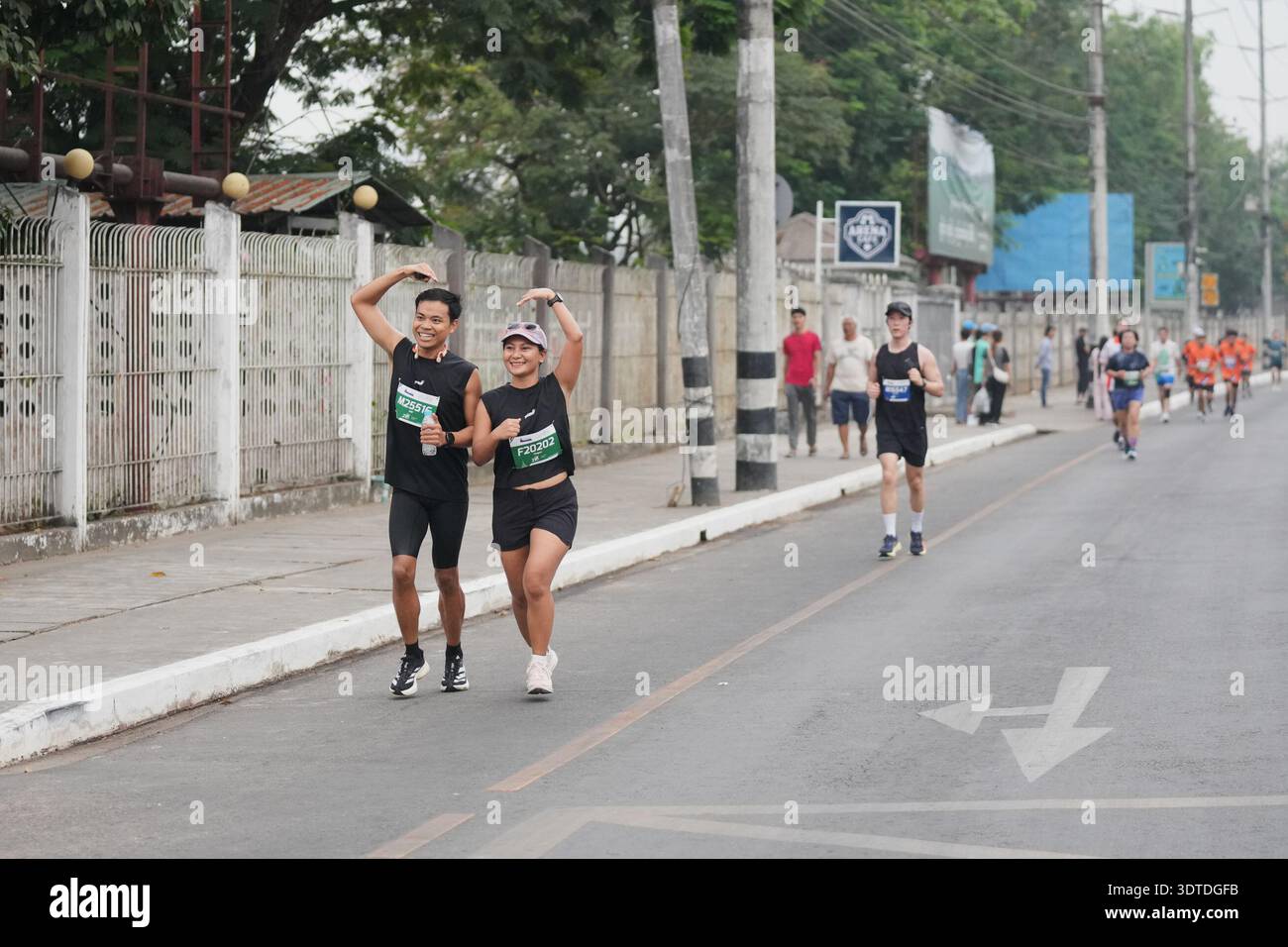 Competitors pose for photos as they take part in the Yoma Yangon ...