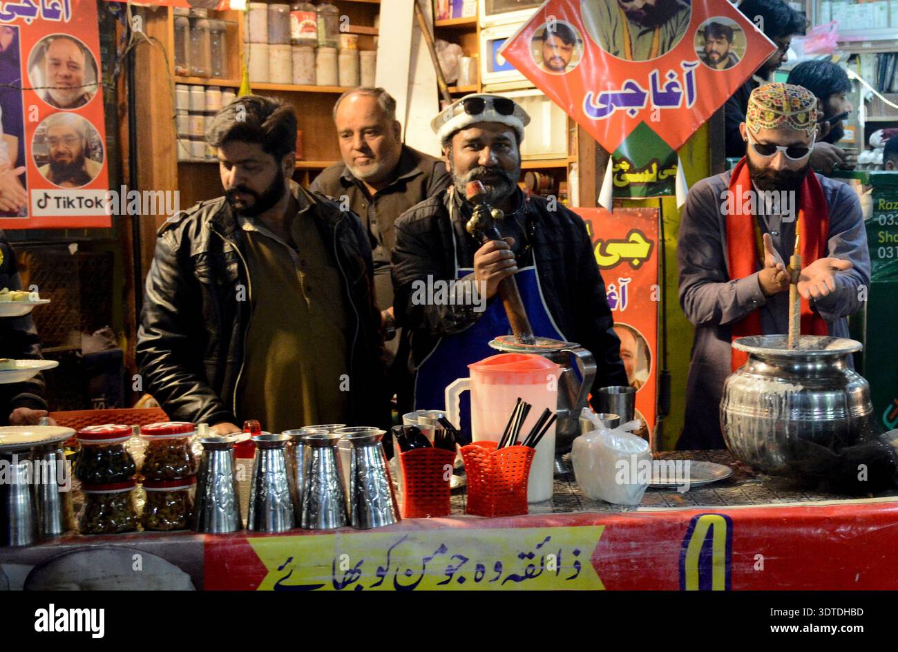 Pakistani men prepare traditional lassi at a restaurant for the pre ...