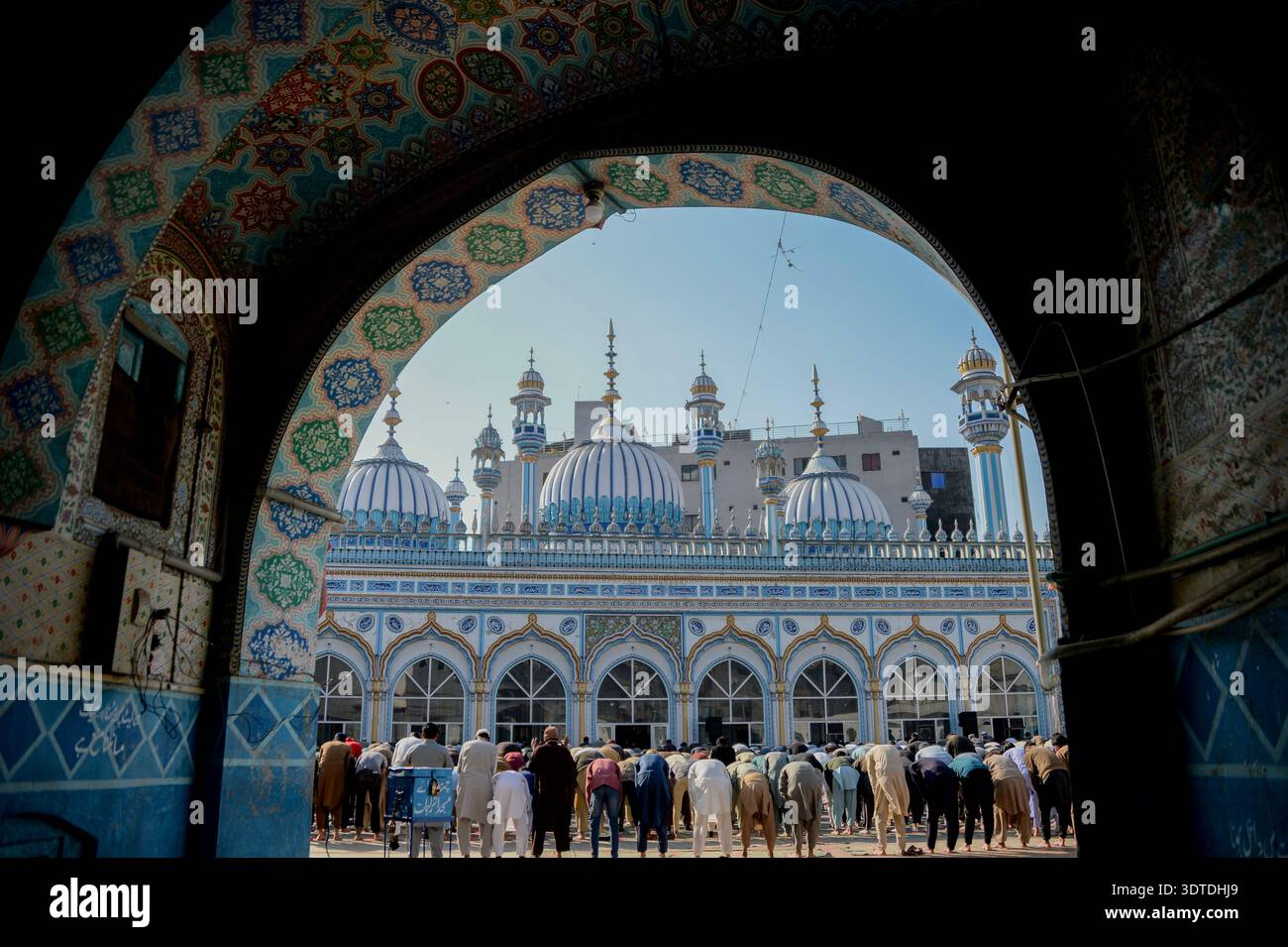 Worshippers perform the first Friday prayer of Ramadan in rows at ...