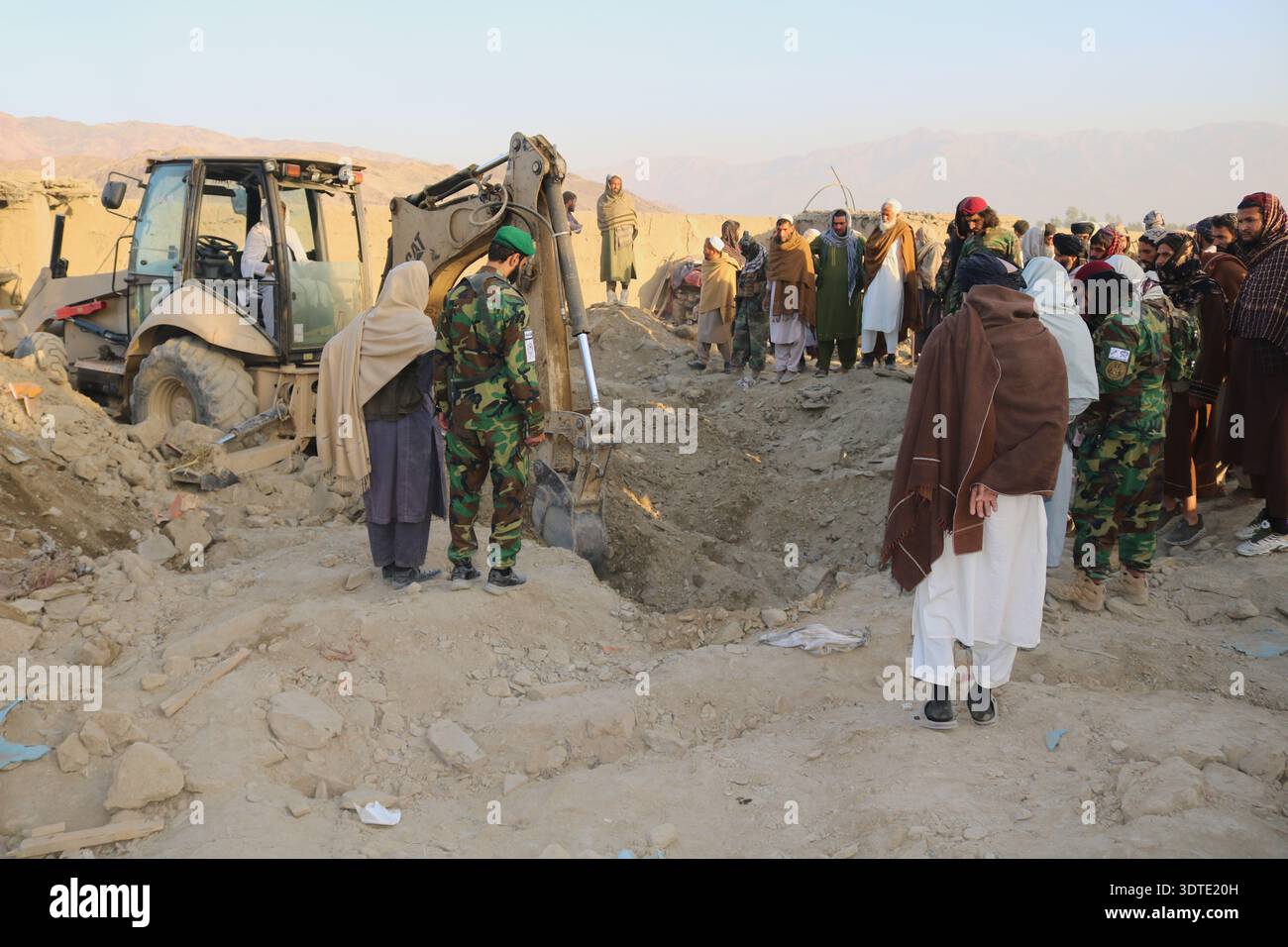 A bulldozer clears the rubble of a house hit by a cross-border ...