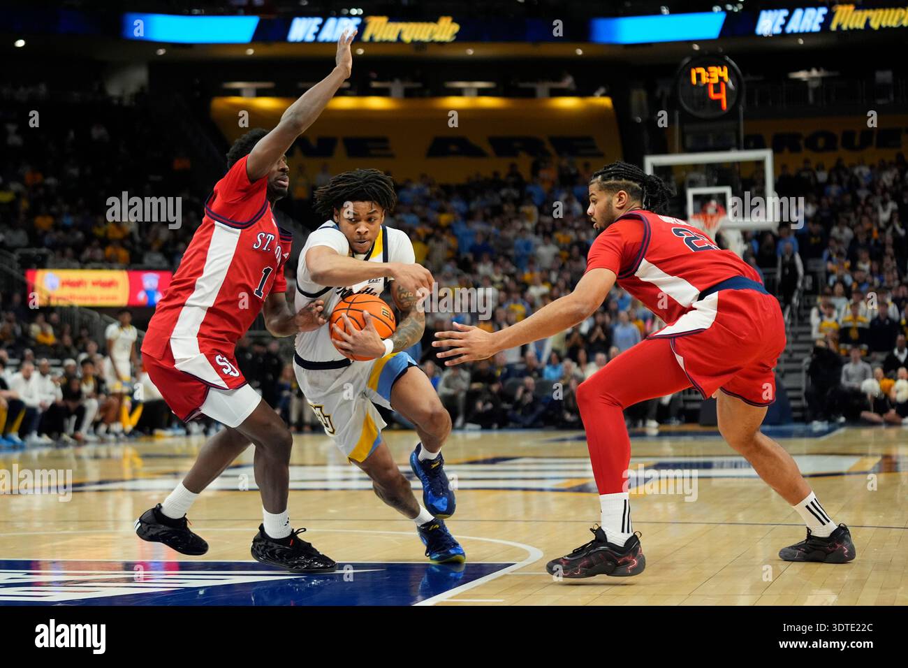 Marquette's Nigel James Jr. drives to the basket between St. John's ...