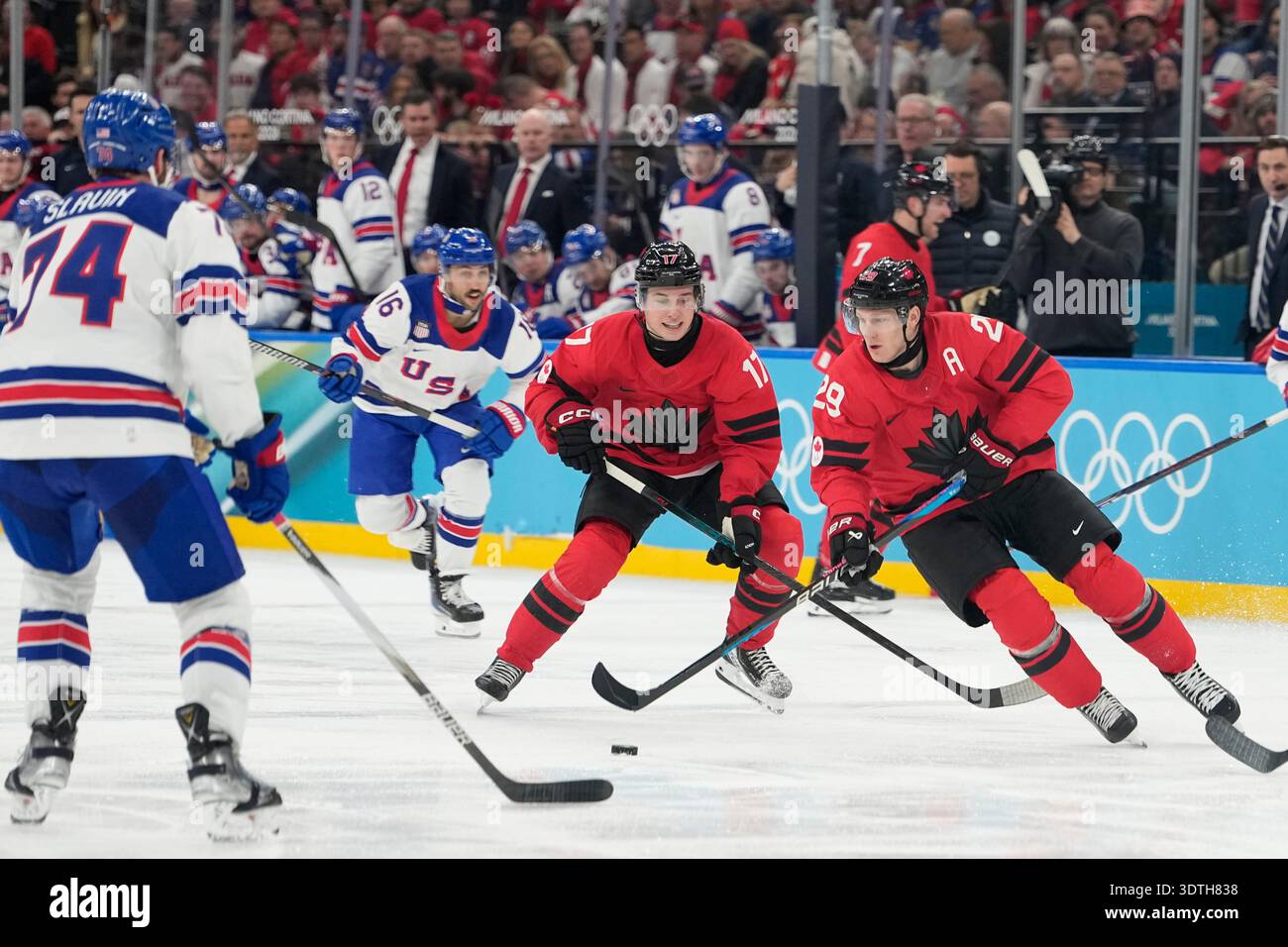 United States' Jaccob Slavin (74), Canada's Macklin Celebrini (17) and ...