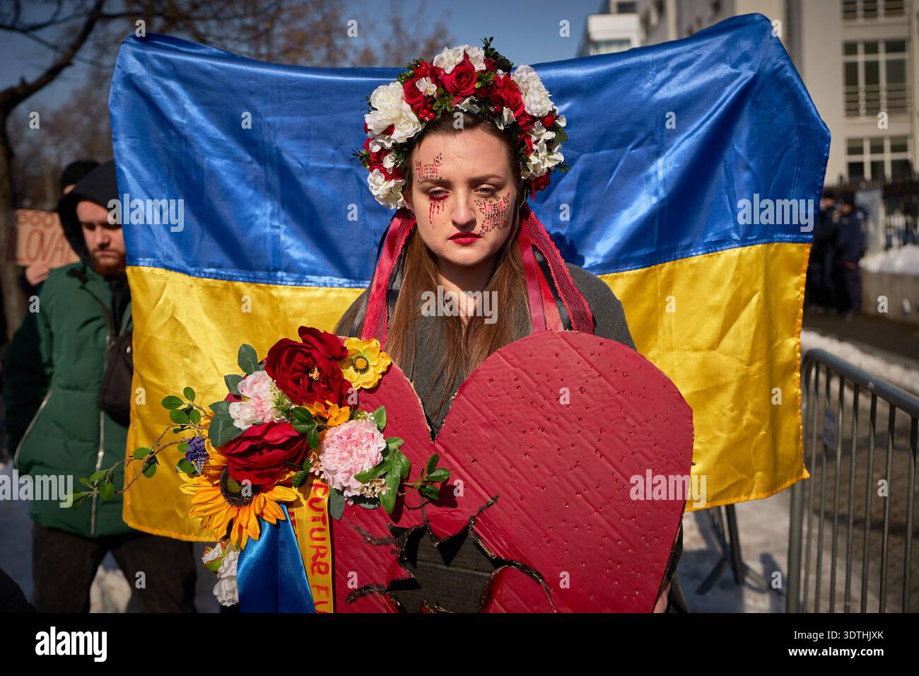 A woman wears a flowers crown as members of the Ukrainian community ...