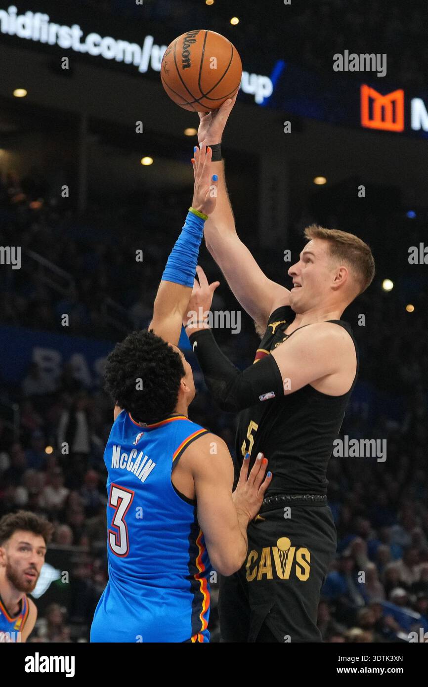 Cleveland Cavaliers guard Sam Merrill, right, looks to shoot over ...