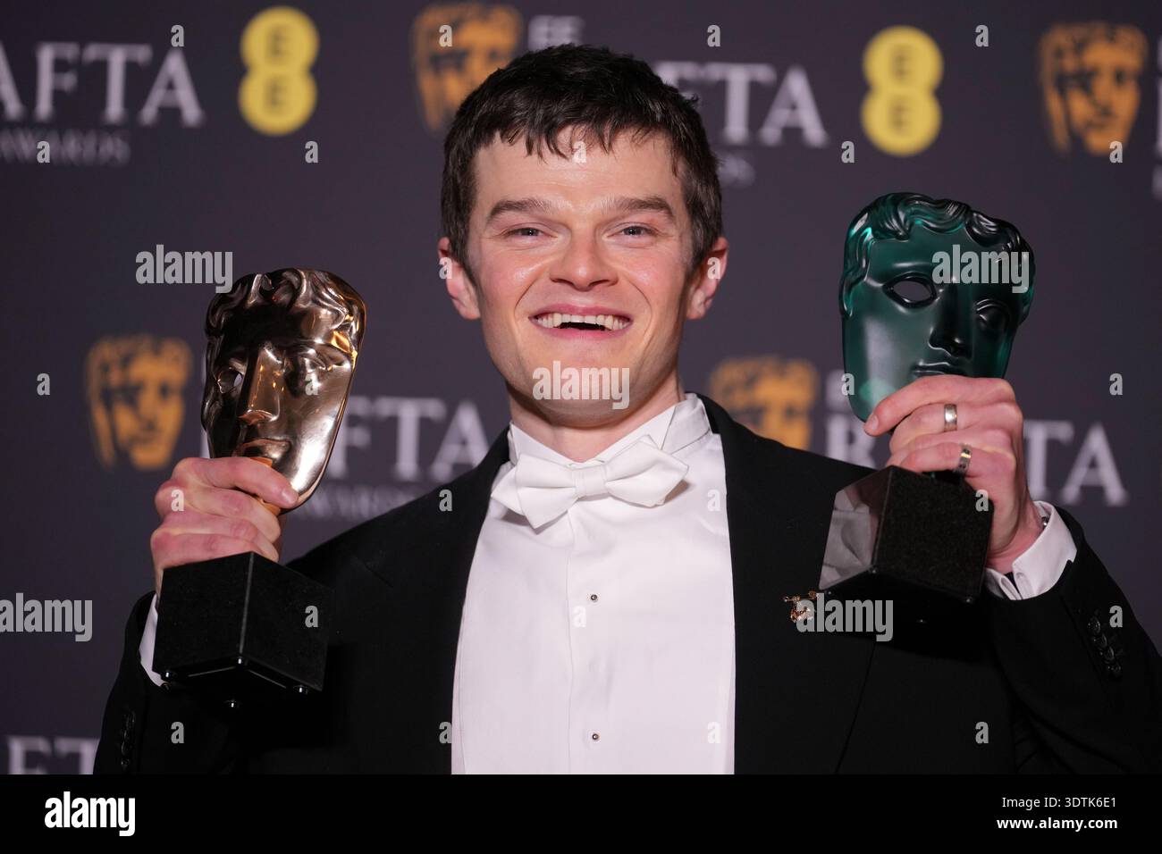 Robert Aramayo poses with the EE rising star award and the award for ...