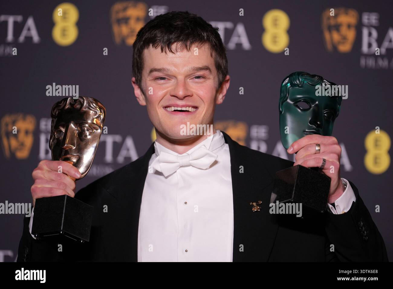 Robert Aramayo poses with the EE rising star award and the award for ...