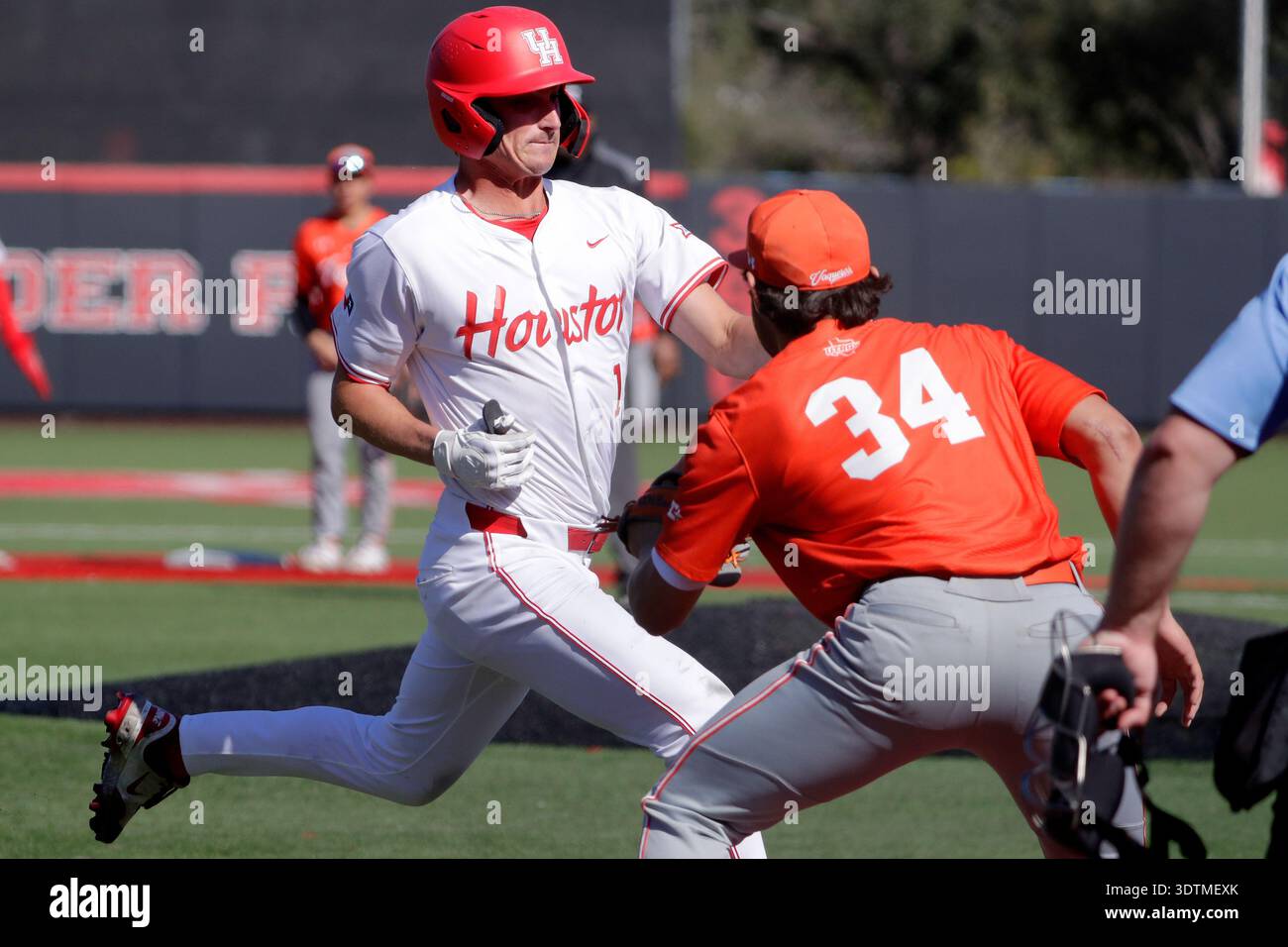 Houston runner Tyler Cox, left, tagged out a the plate on a pickle play ...