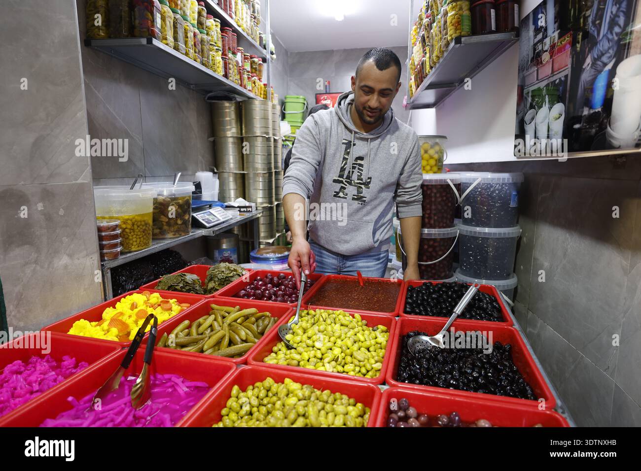 (260223) -- JERUSALEM, Feb. 23, 2026 (Xinhua) -- A shopkeeper prepares ...