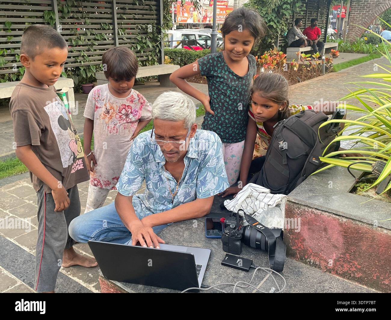 Associated Press photographer Rajanish Kakade works, watched by ...
