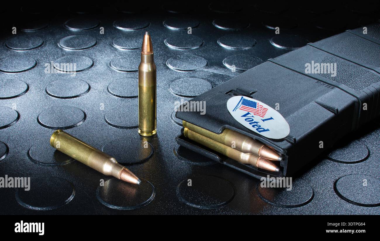 I voted sticker on a fully loaded AR-15 magazine with cartridges nearby ...