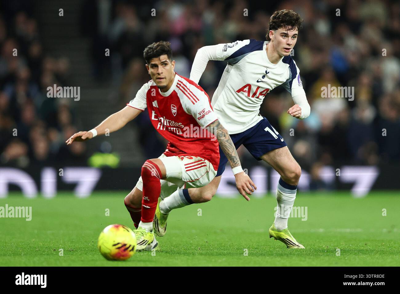 Archie Gray of Tottenham Hotspur dummies past Piero Hincapie of Arsenal ...