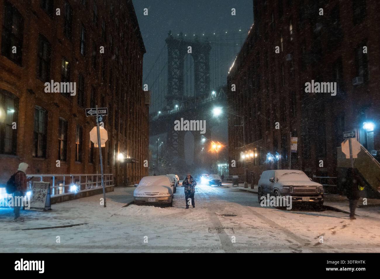 People take photos on Washington Street as snow falls during a major ...