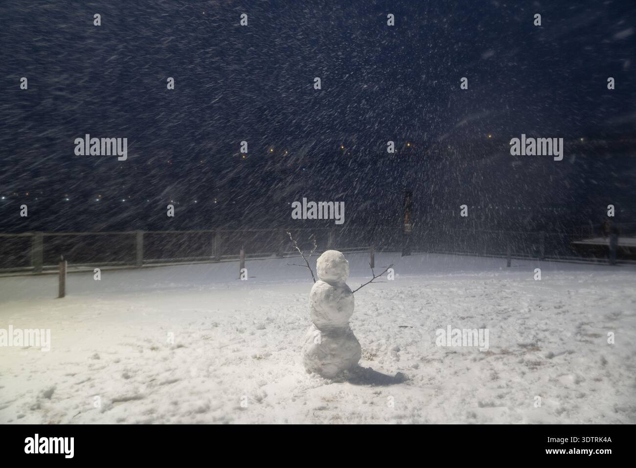 A snowman stands below the Brooklyn Bridge as snow falls during a major ...