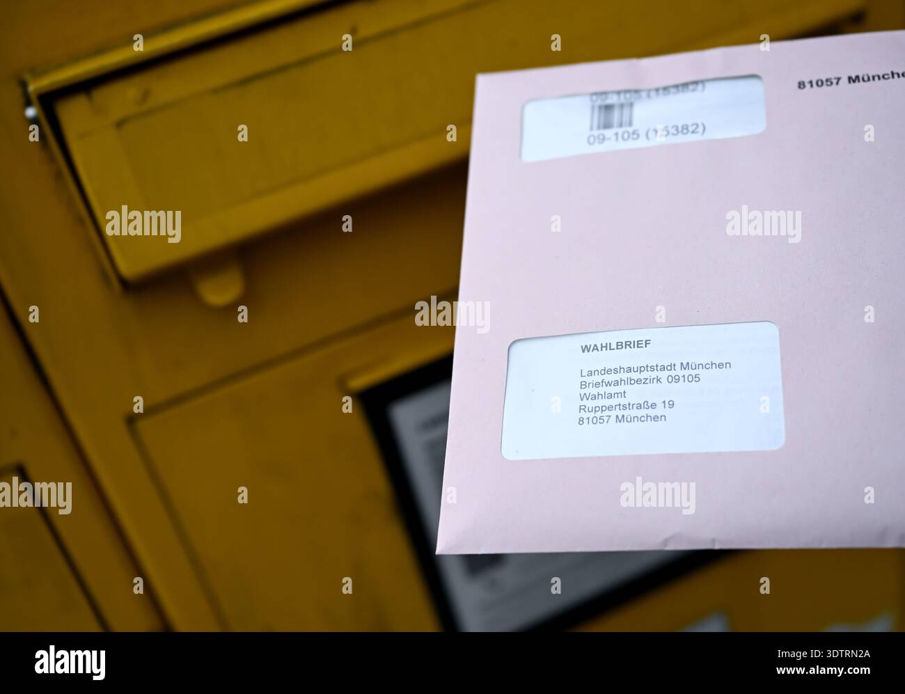 23 February 2026, Bavaria, Munich: A woman drops an election letter for ...