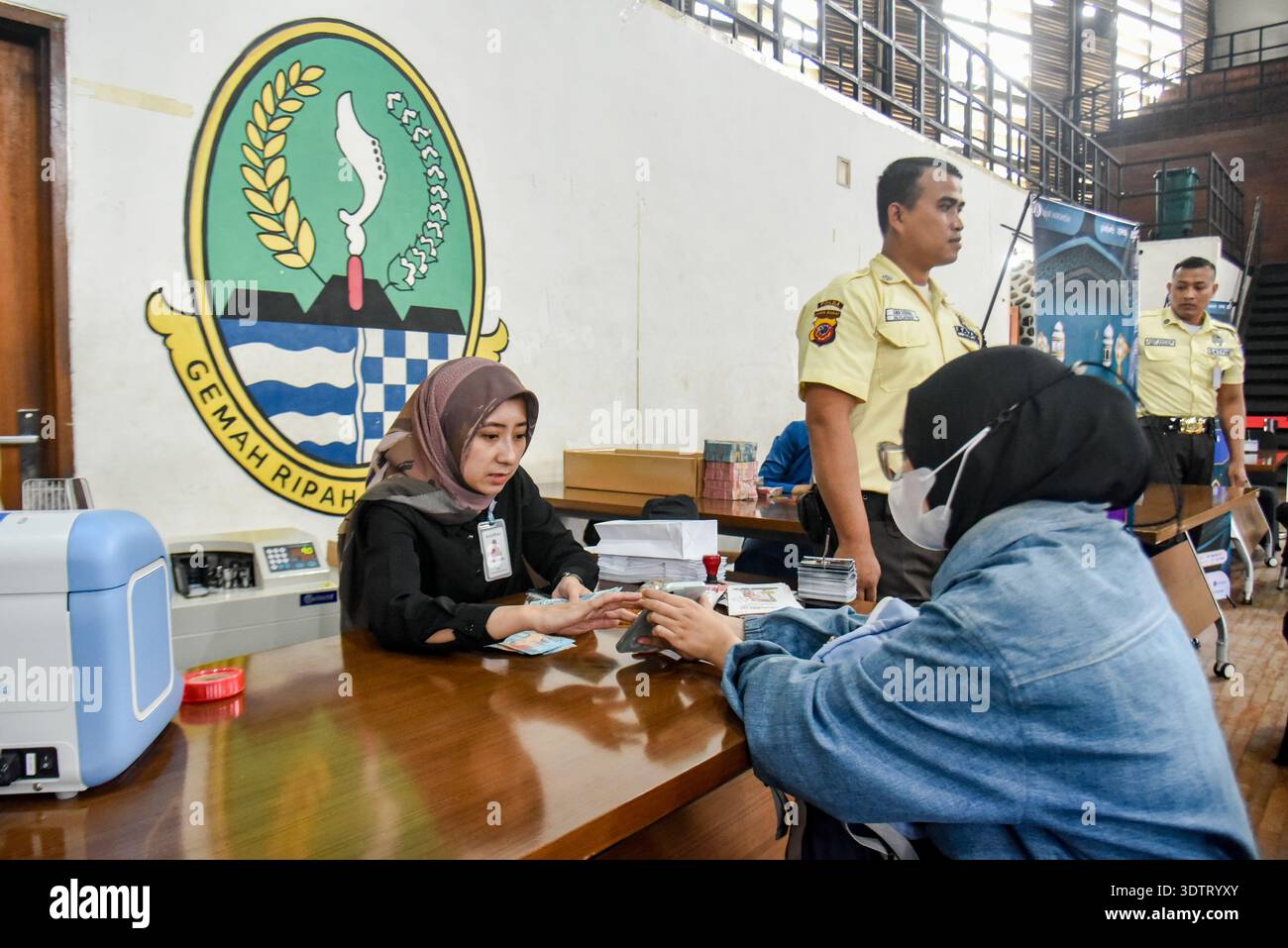 February 23, 2026, Bandung, West Java, Indonesia: People exchange their ...