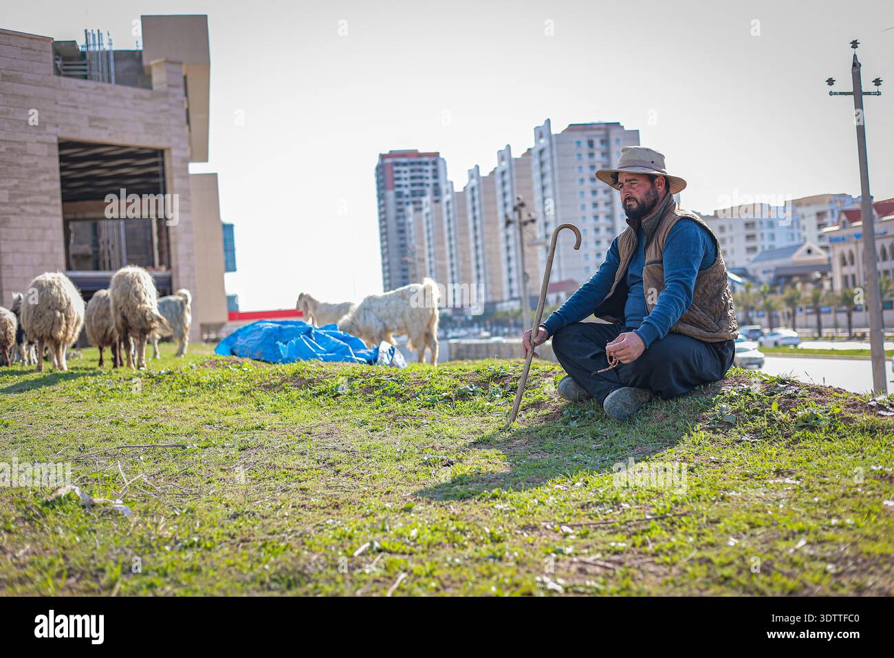 Kurdish shepherd Mohamad Hashim rests with his prayer beads and ...