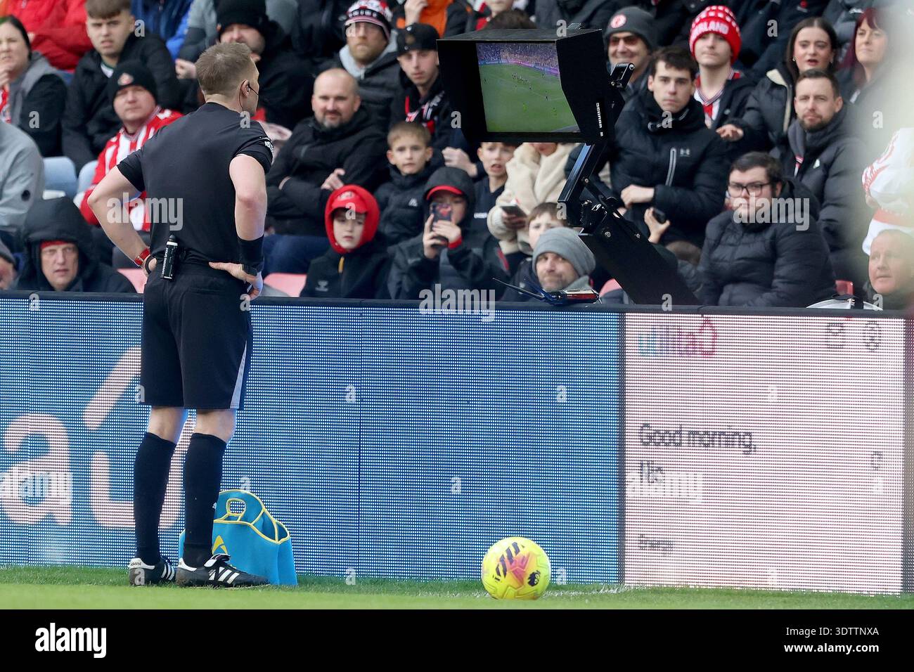 Match referee Craig Pawson examines the VAR screen during the Premier ...