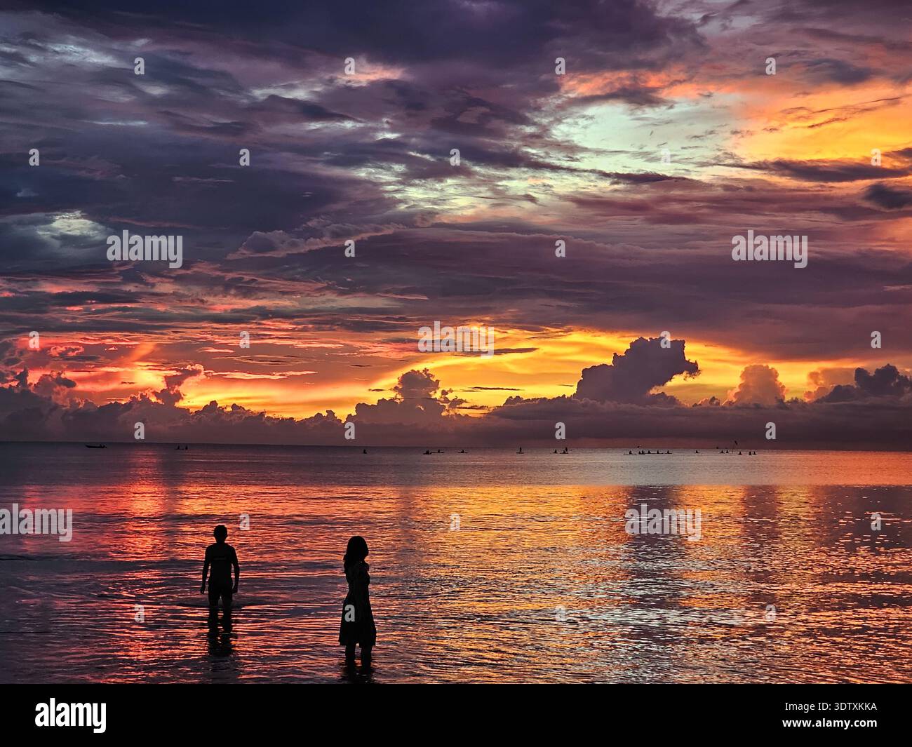 Silhouette of people watching the world-famous sunset at Tanjung Aru ...