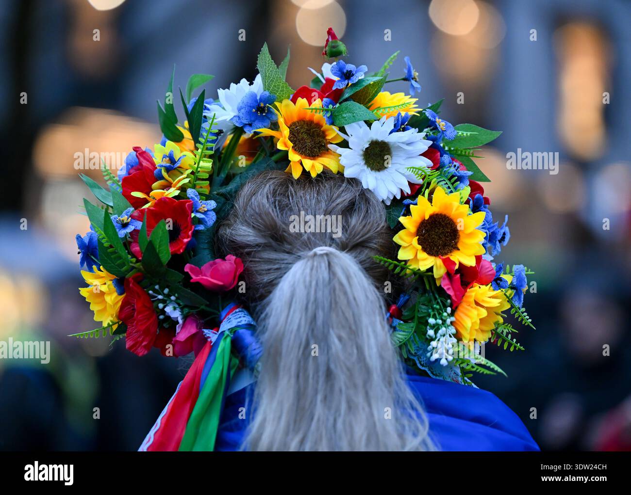 24 February 2026, Bavaria, Munich: A woman takes part in a rally on ...