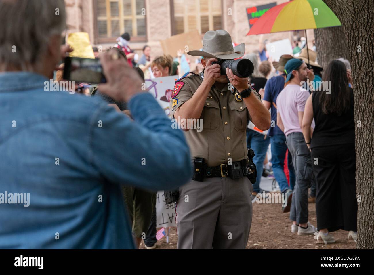 DPS Trooper takes photographs during the 50501 Movement rally and march ...