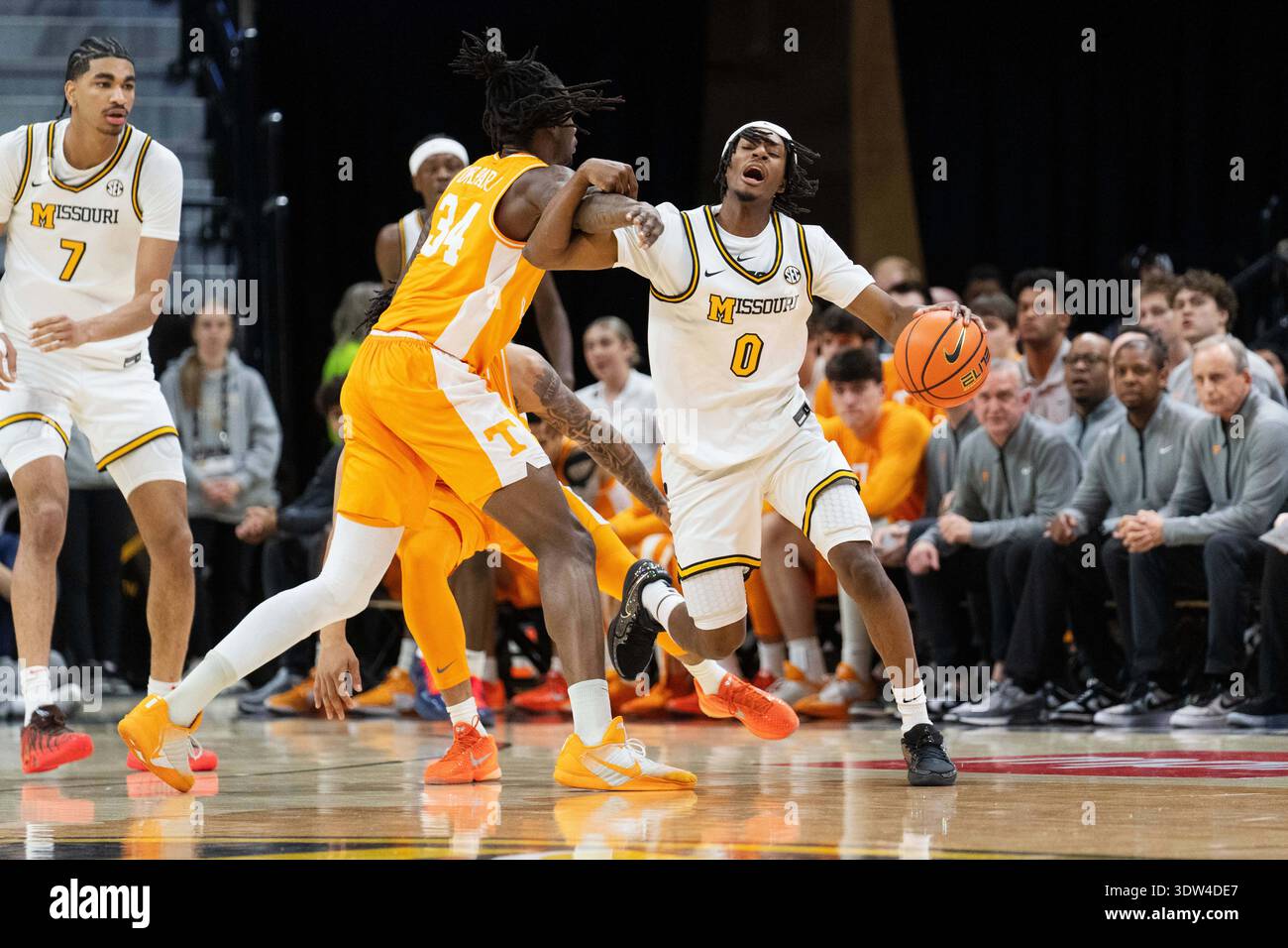 Missouri's Anthony Robinson II (0) drives past Tennessee's Felix Okpara ...
