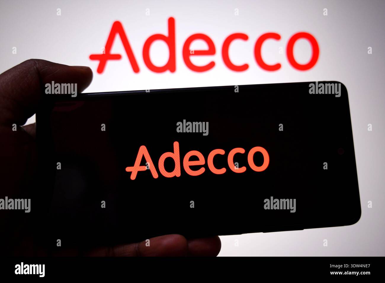 In this photo illustration, an Adecco logo is seen displayed on a ...