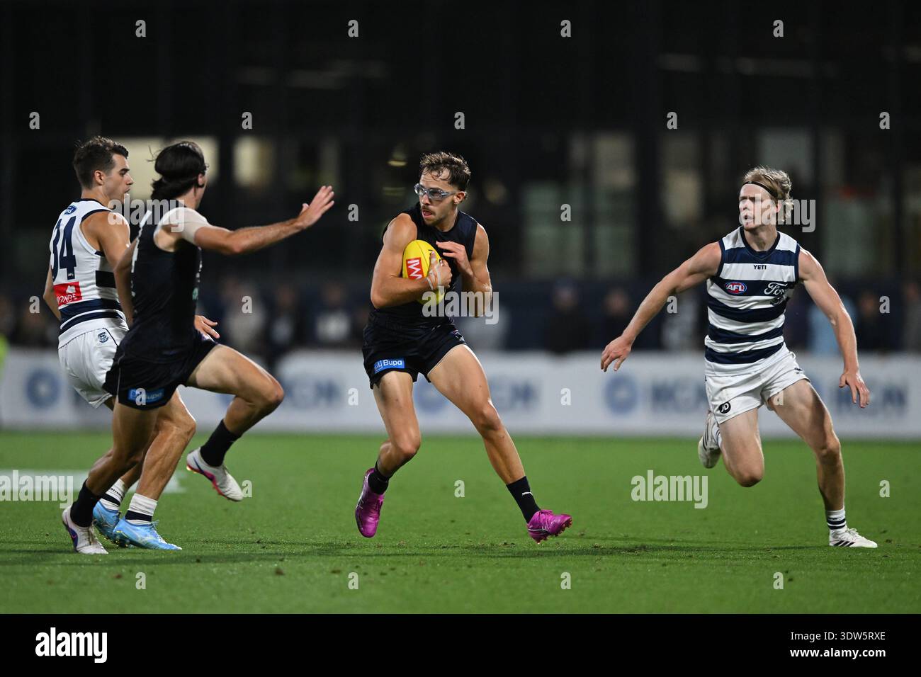 Francis Evans of Carlton (centre) in action during the AFL Community ...