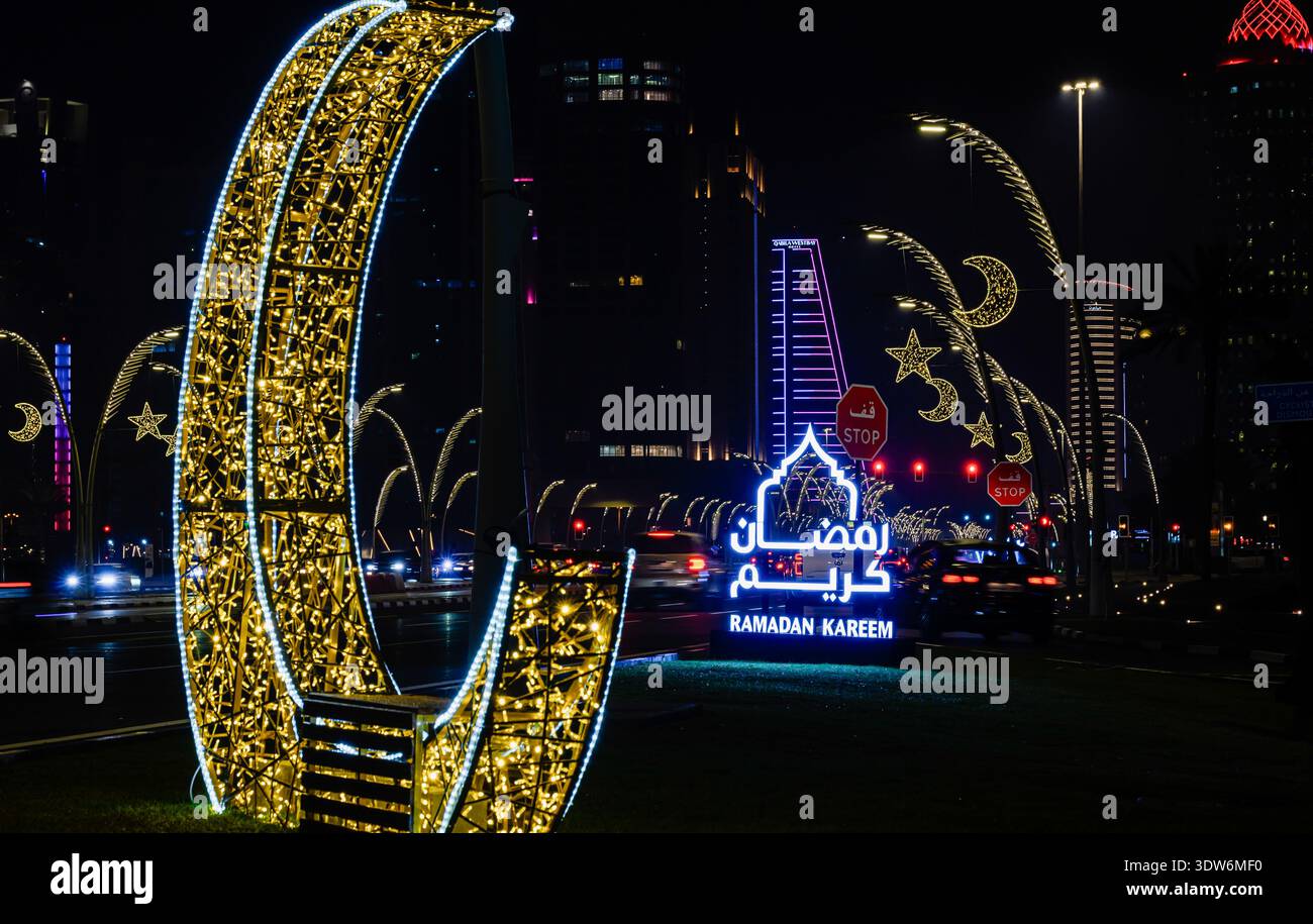 Vehicles drive along a road decorated with illuminated Ramadan-themed ...