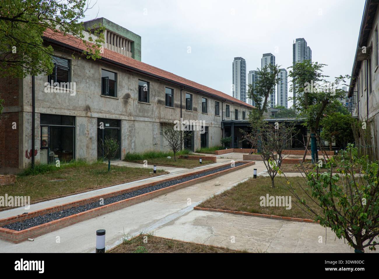 Wide view of a landscaped courtyard within a converted industrial ...