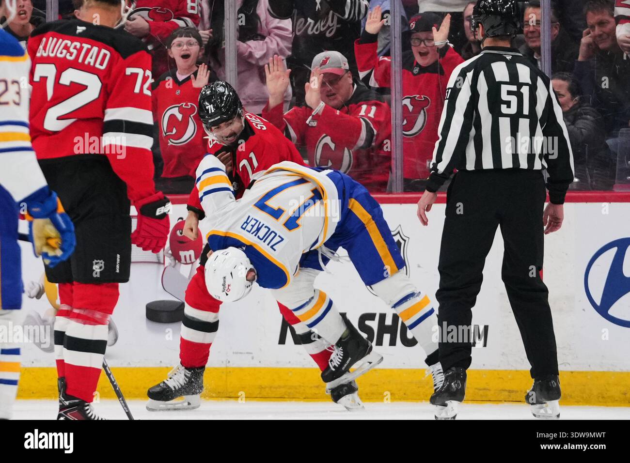 New Jersey Devils' Jonas Siegenthaler (71) fights with Buffalo Sabres ...